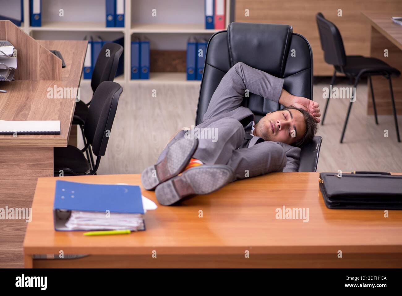 Young employee sleeping at workplace Stock Photo - Alamy