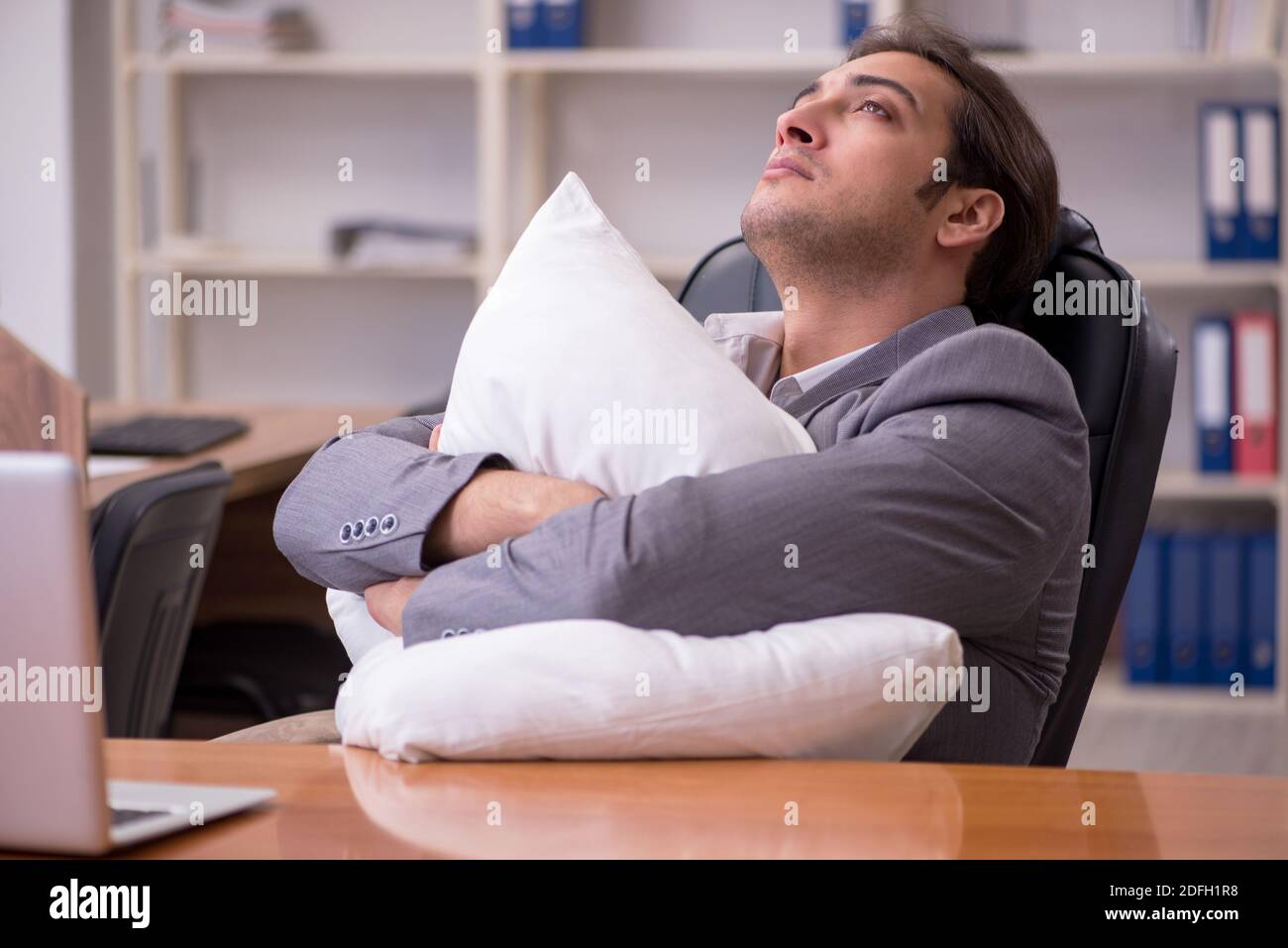 Young employee sleeping at workplace Stock Photo - Alamy