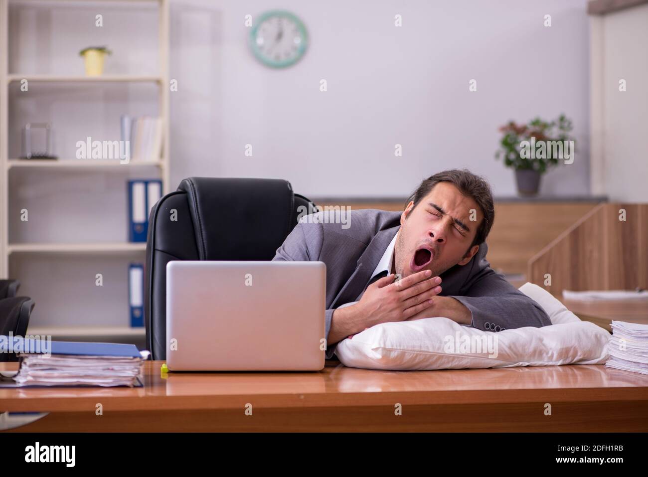 Young employee sleeping at workplace Stock Photo - Alamy