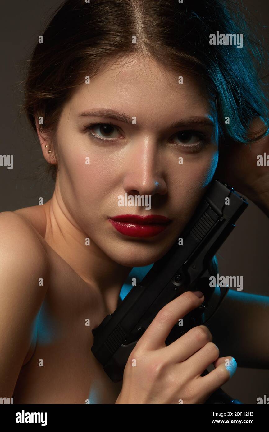 serious young woman with gun looking at camera closeup portrait Stock ...