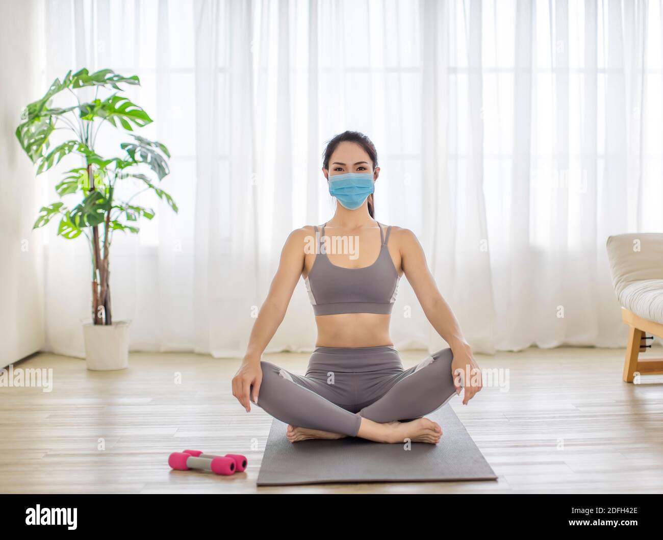 Fitness woman streching Relaxing after training and wearing protectve ...