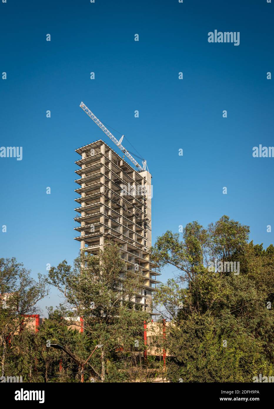New construction high-rise building with crane Stock Photo - Alamy