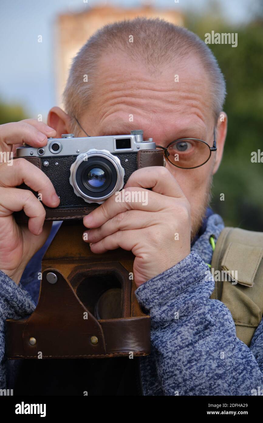 photographer with old style camera looking at camera taking shot Stock ...