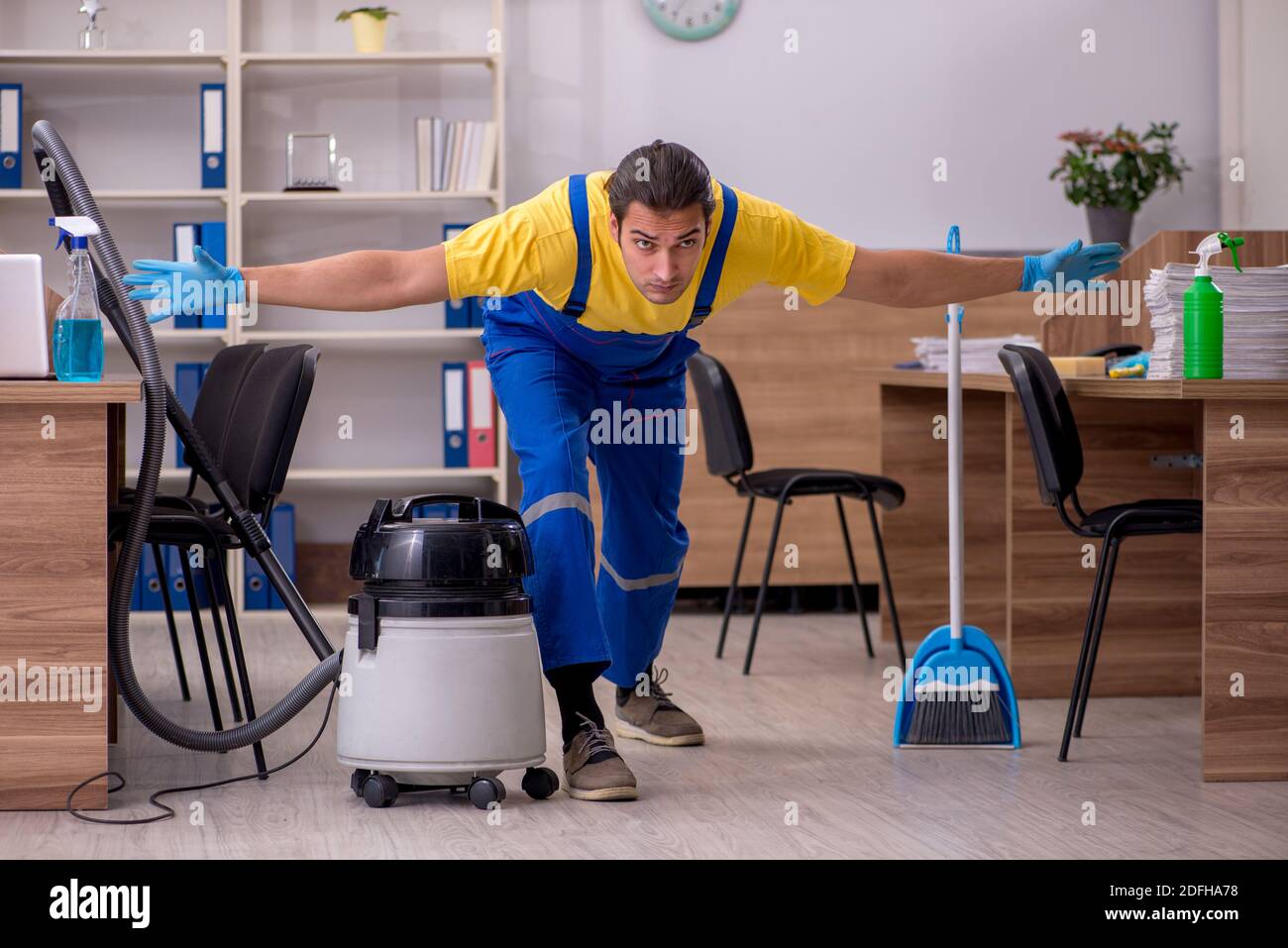 Male contractor cleaning the office Stock Photo - Alamy