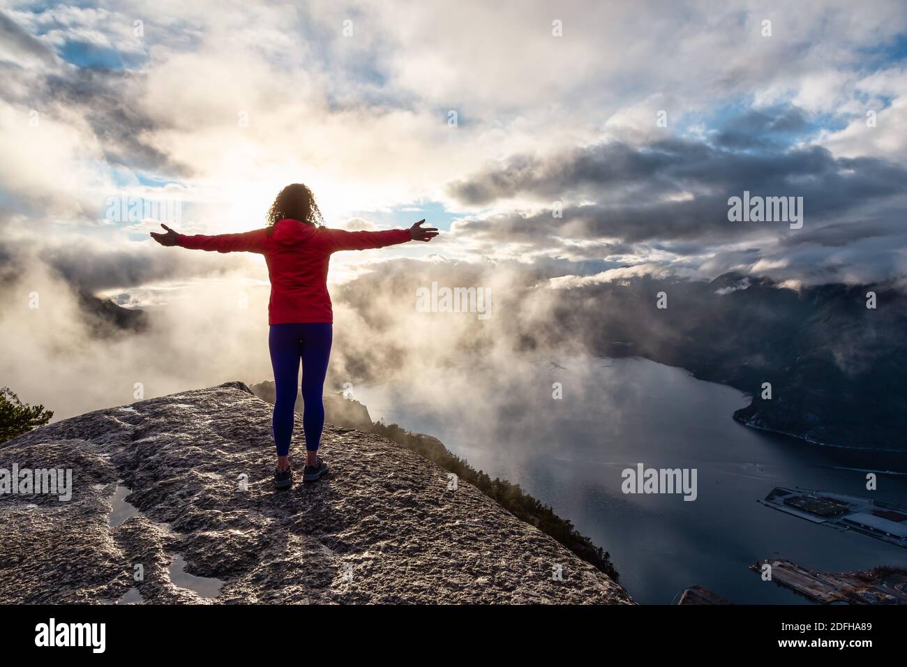 Adventurous Girl Hiking on top of a Peak Stock Photo - Alamy