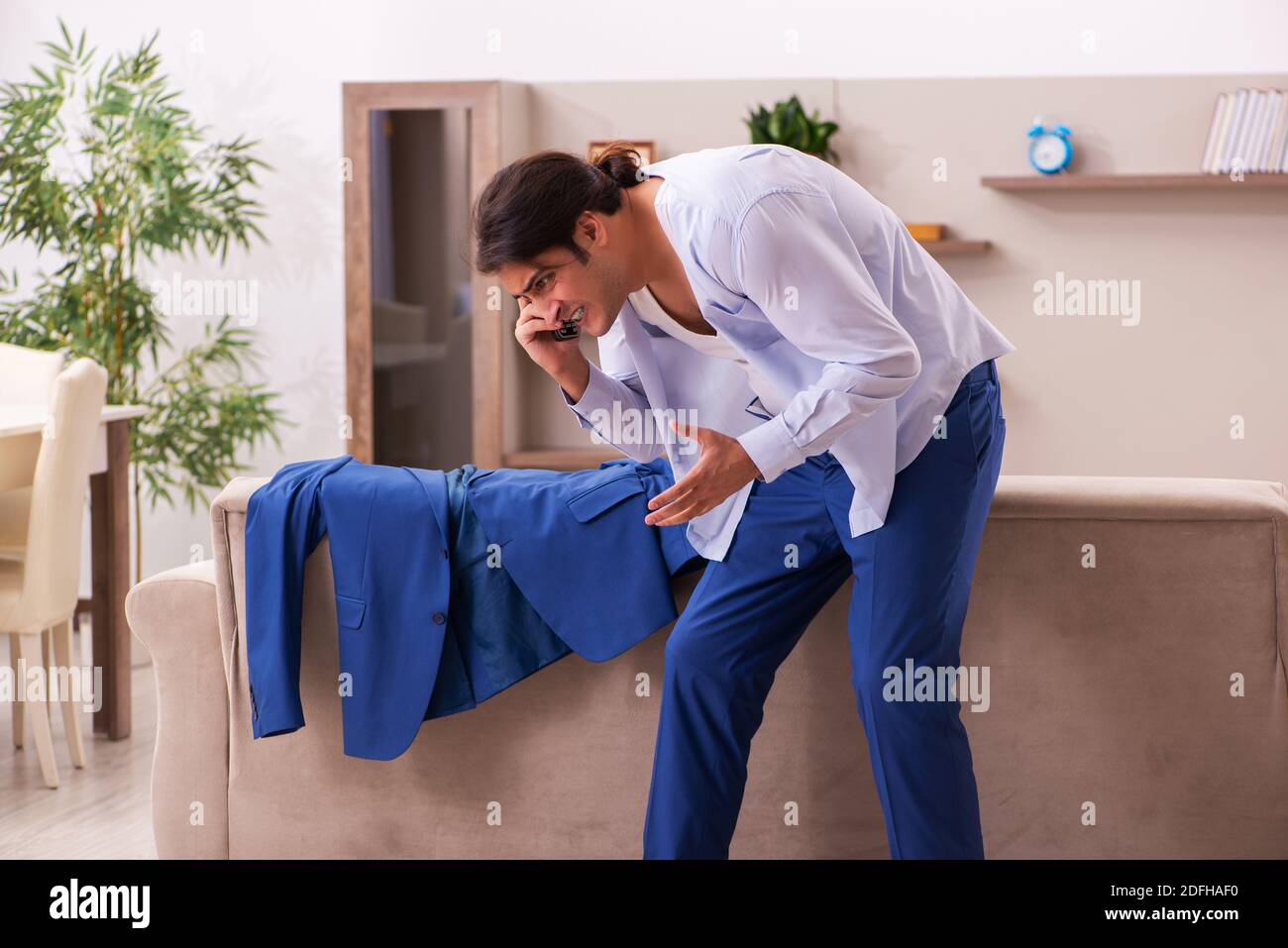 Young employee getting up late at home Stock Photo - Alamy