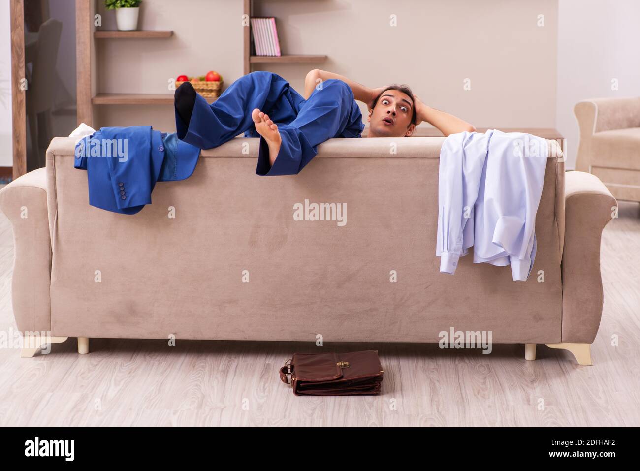 Young employee getting up late at home Stock Photo - Alamy