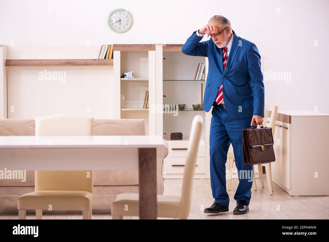 Senior male boss employee coming home from work Stock Photo - Alamy