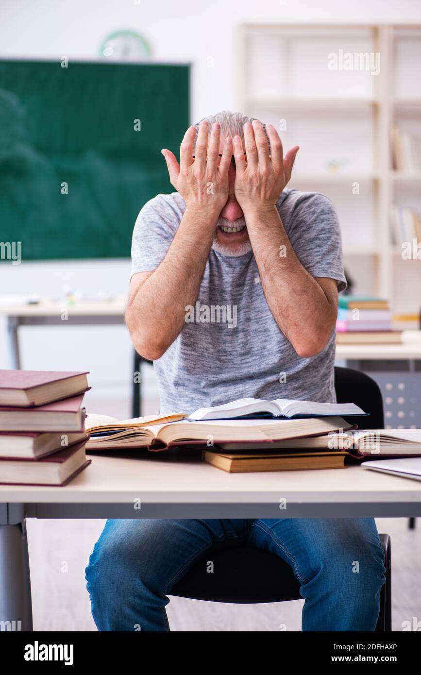 Senior male student being exhausted during exam preparation Stock Photo ...