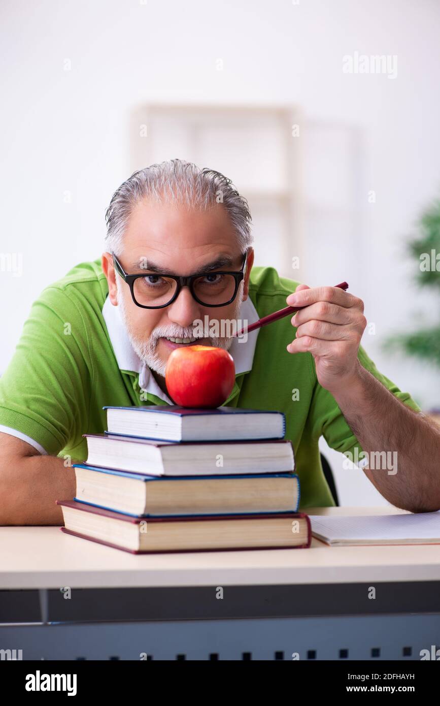 Male teacher eating apple hi-res stock photography and images - Alamy