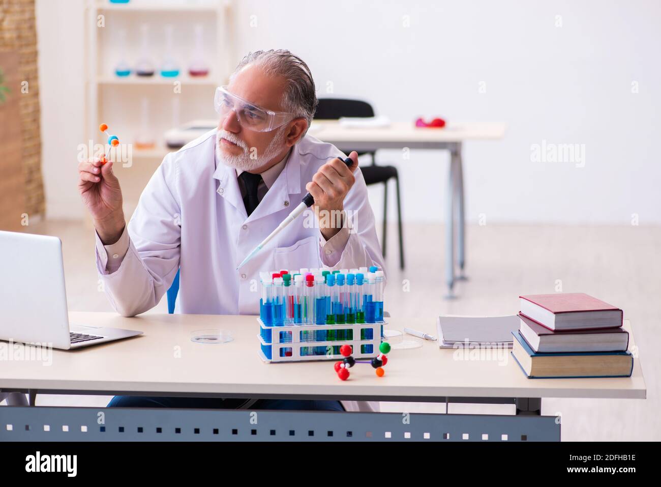 Senior male scientist examining glass hi-res stock photography and ...