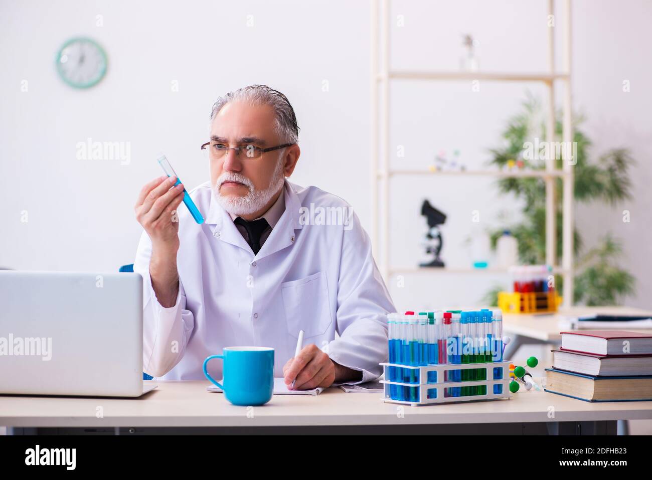 Senior male chemist taking notes Stock Photo - Alamy