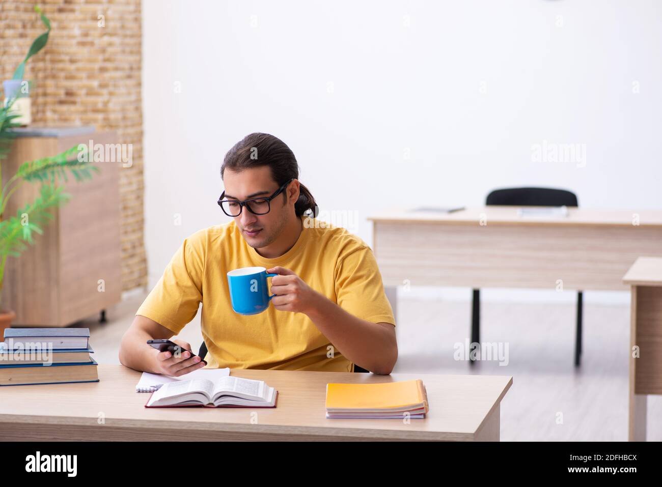 Young student having break during exam preparation Stock Photo - Alamy