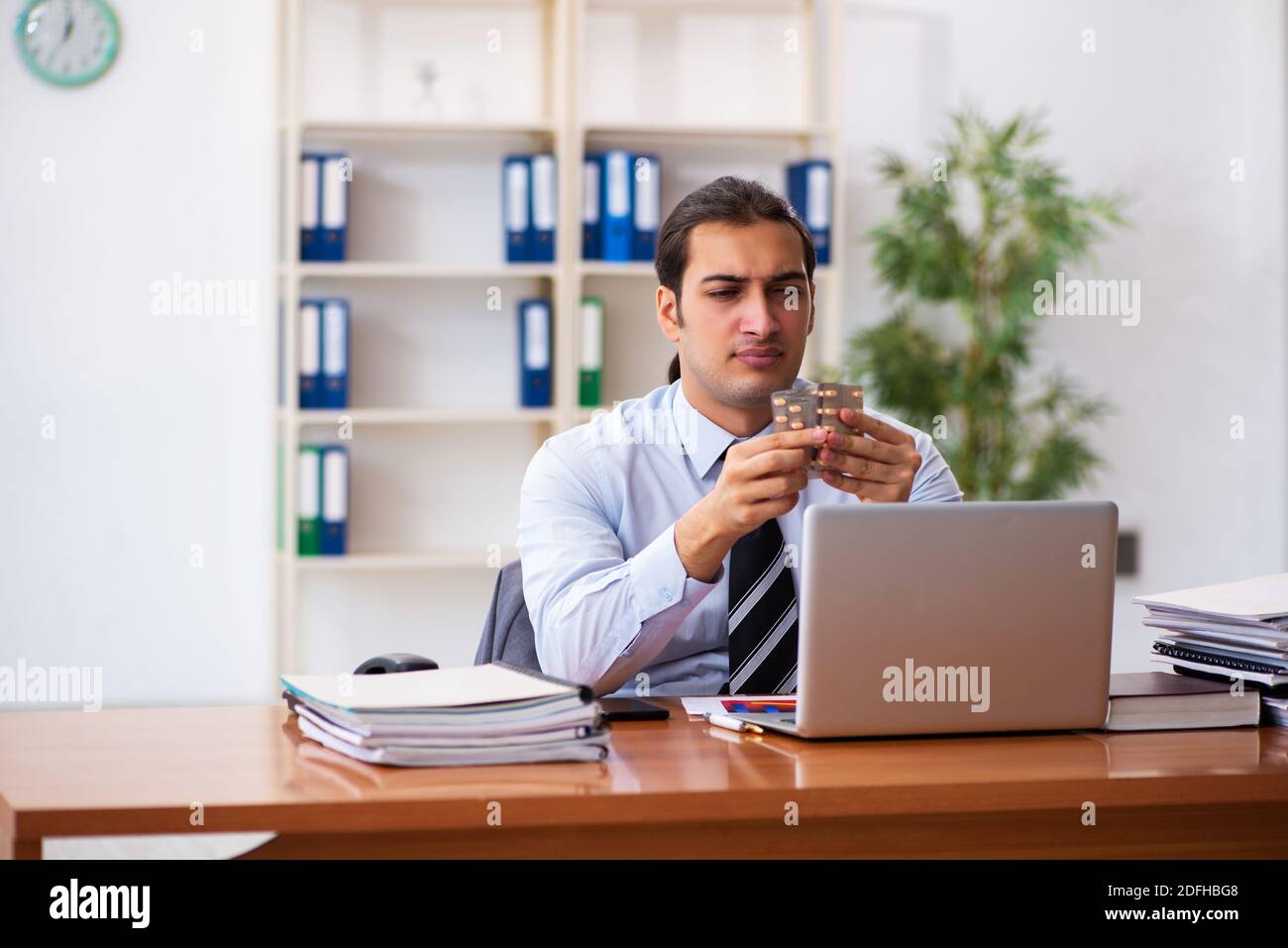 Sick employee working in the office Stock Photo - Alamy