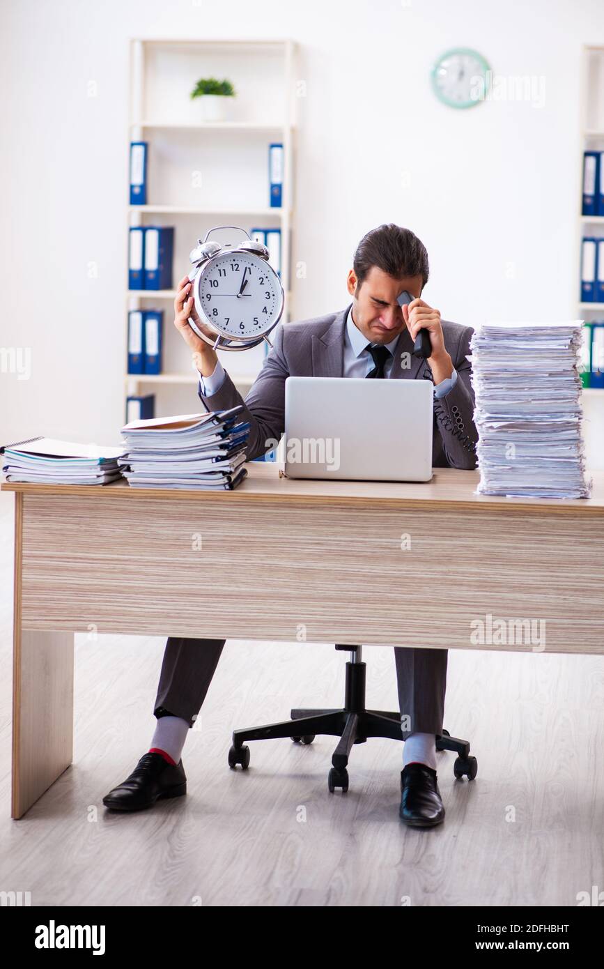 Workload employee in time management concept Stock Photo - Alamy