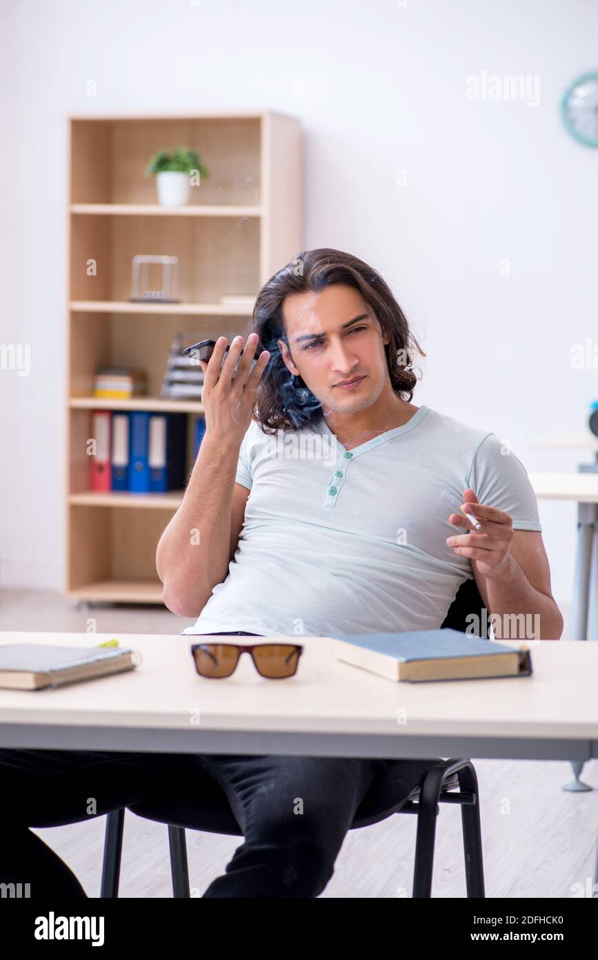 Male student smoking cigarettes in the classroom Stock Photo - Alamy