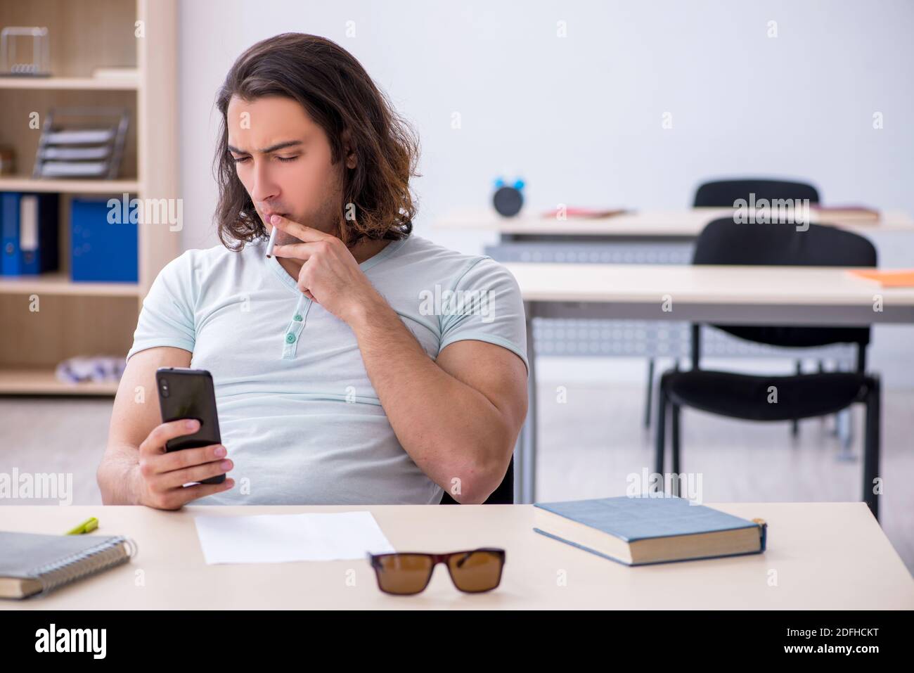 Male student smoking cigarettes in the classroom Stock Photo - Alamy