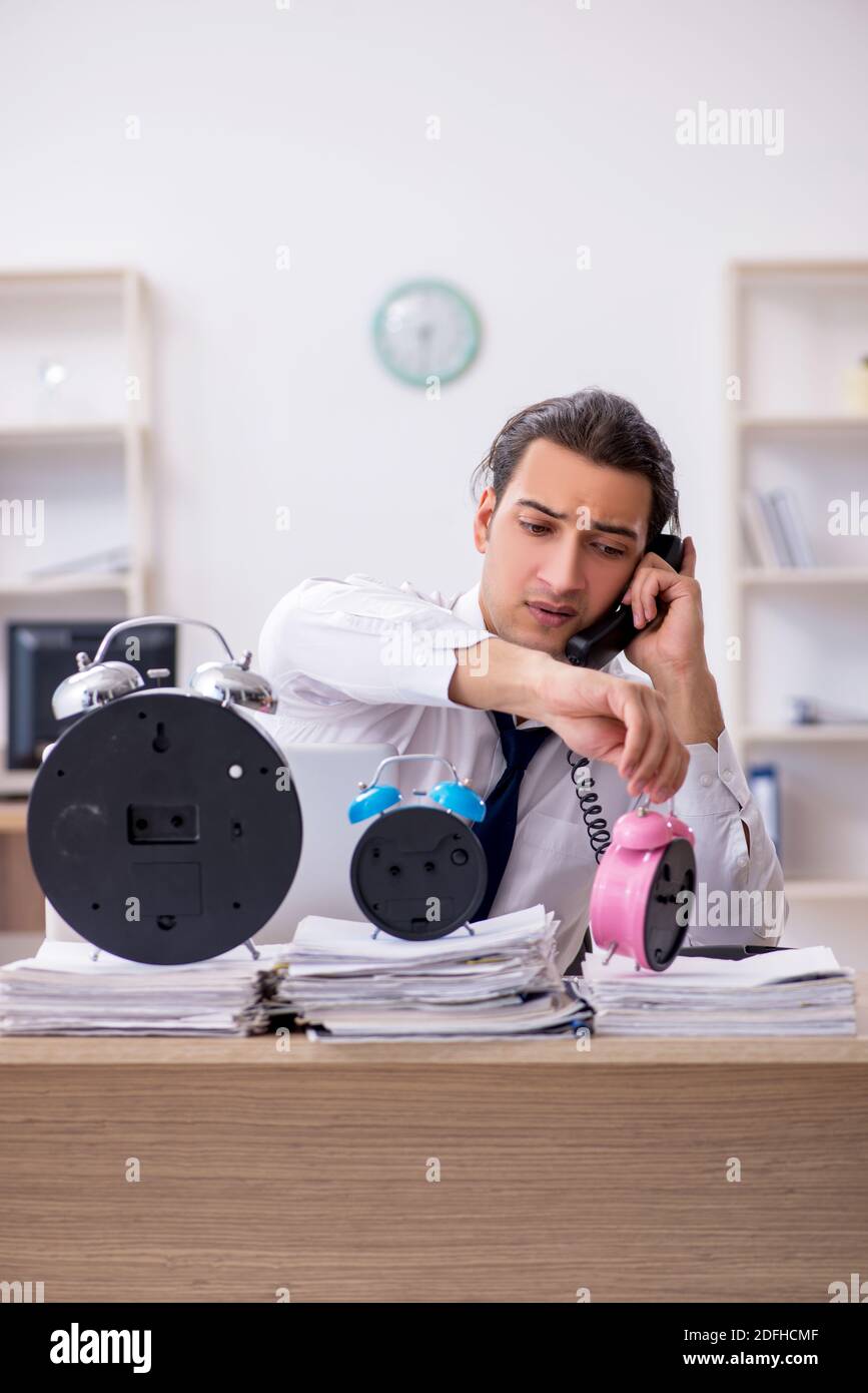 Young employee afraid of missing deadline at workplace Stock Photo - Alamy