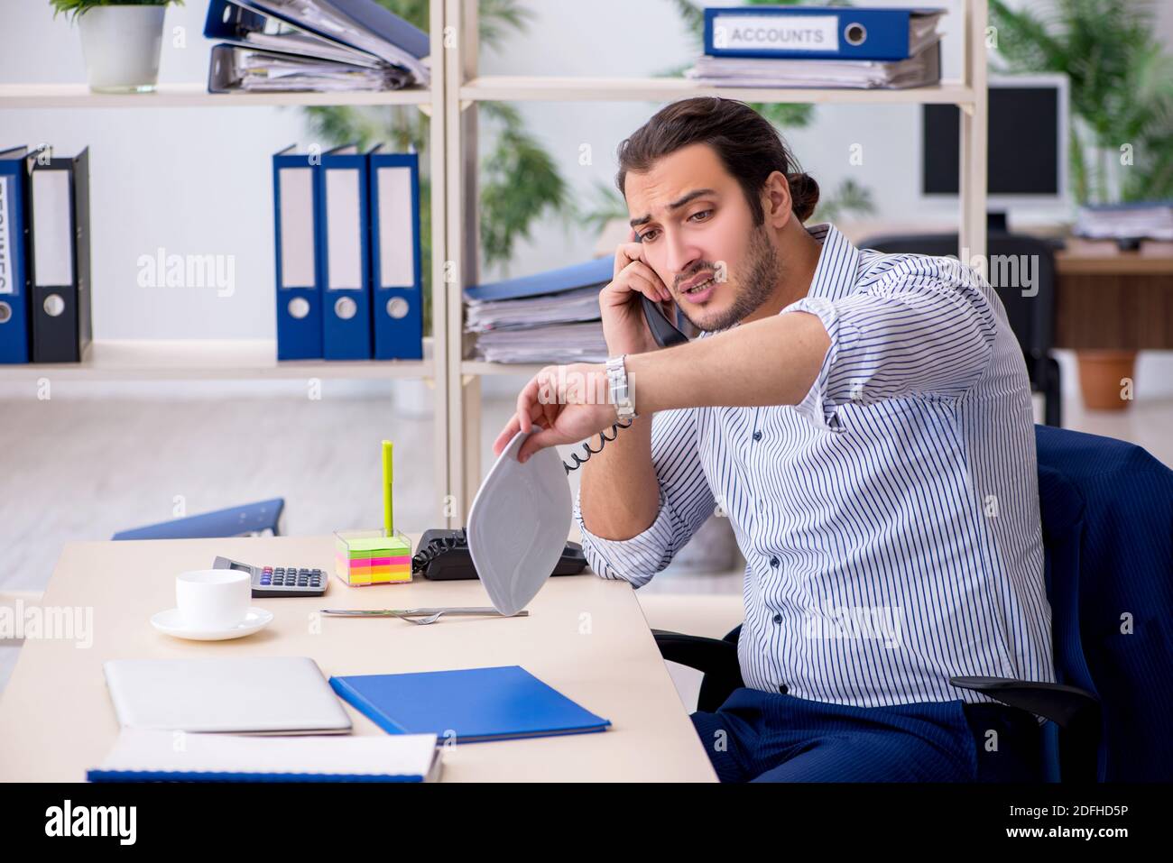 Hungry employee waiting for food in time management concept Stock Photo ...