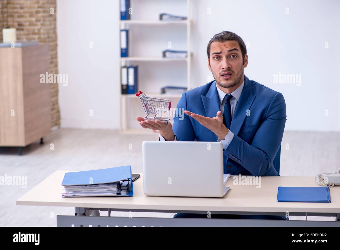 Young employee in e-commerce concept Stock Photo - Alamy