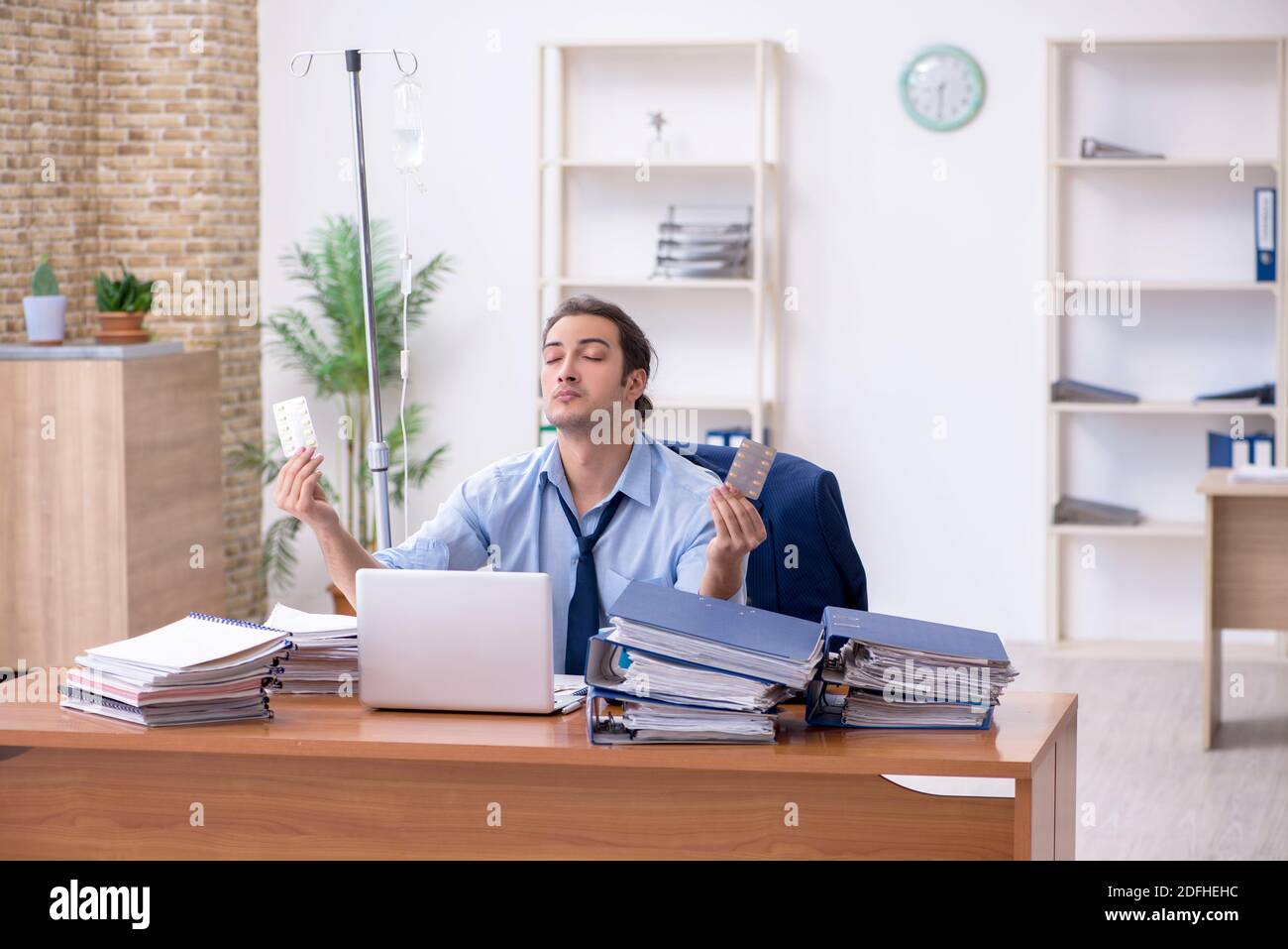 Male employee suffering at workplace Stock Photo - Alamy