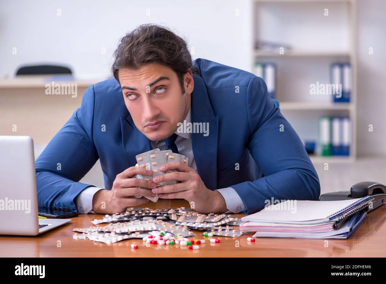 Sick male employee suffering at workplace Stock Photo - Alamy