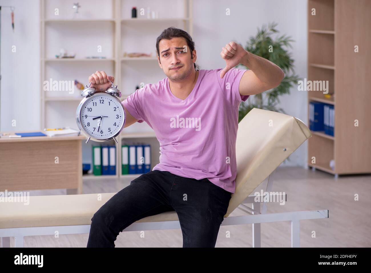 Male patient waiting for doctor in time management concept Stock Photo ...