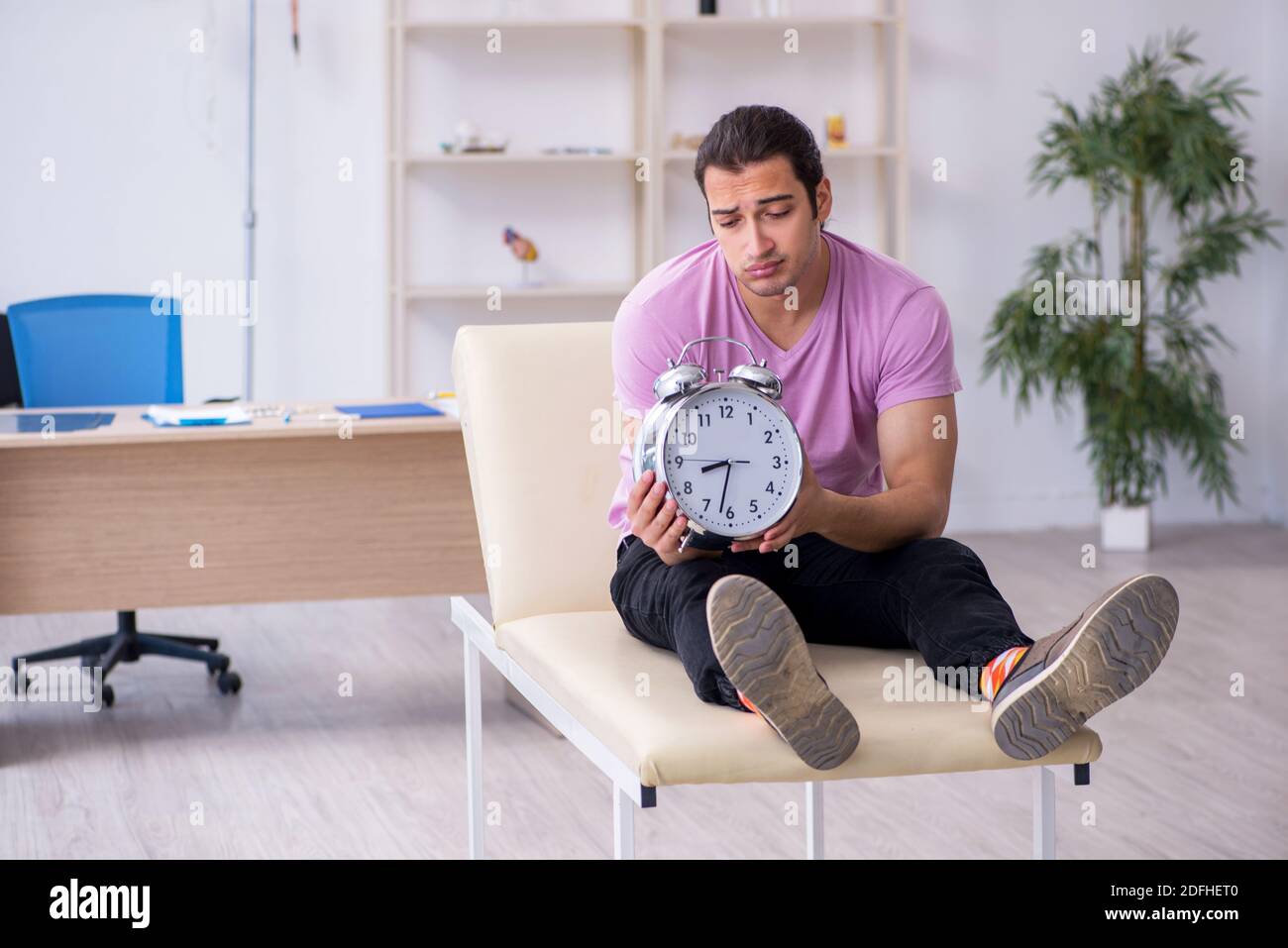 Male patient waiting for doctor in time management concept Stock Photo ...