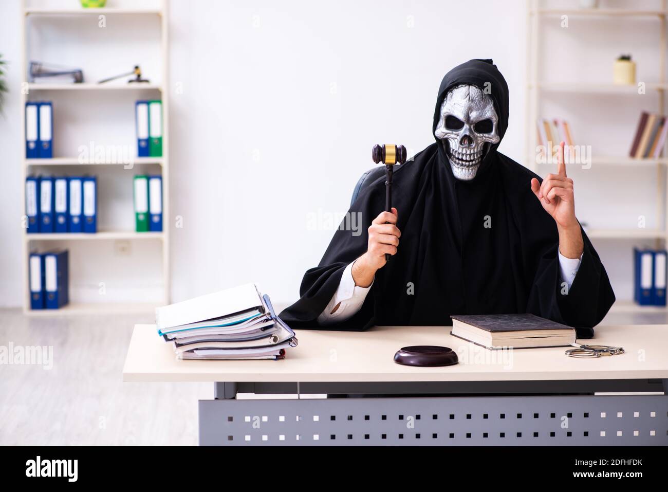 Devil judge working in the courthouse Stock Photo - Alamy