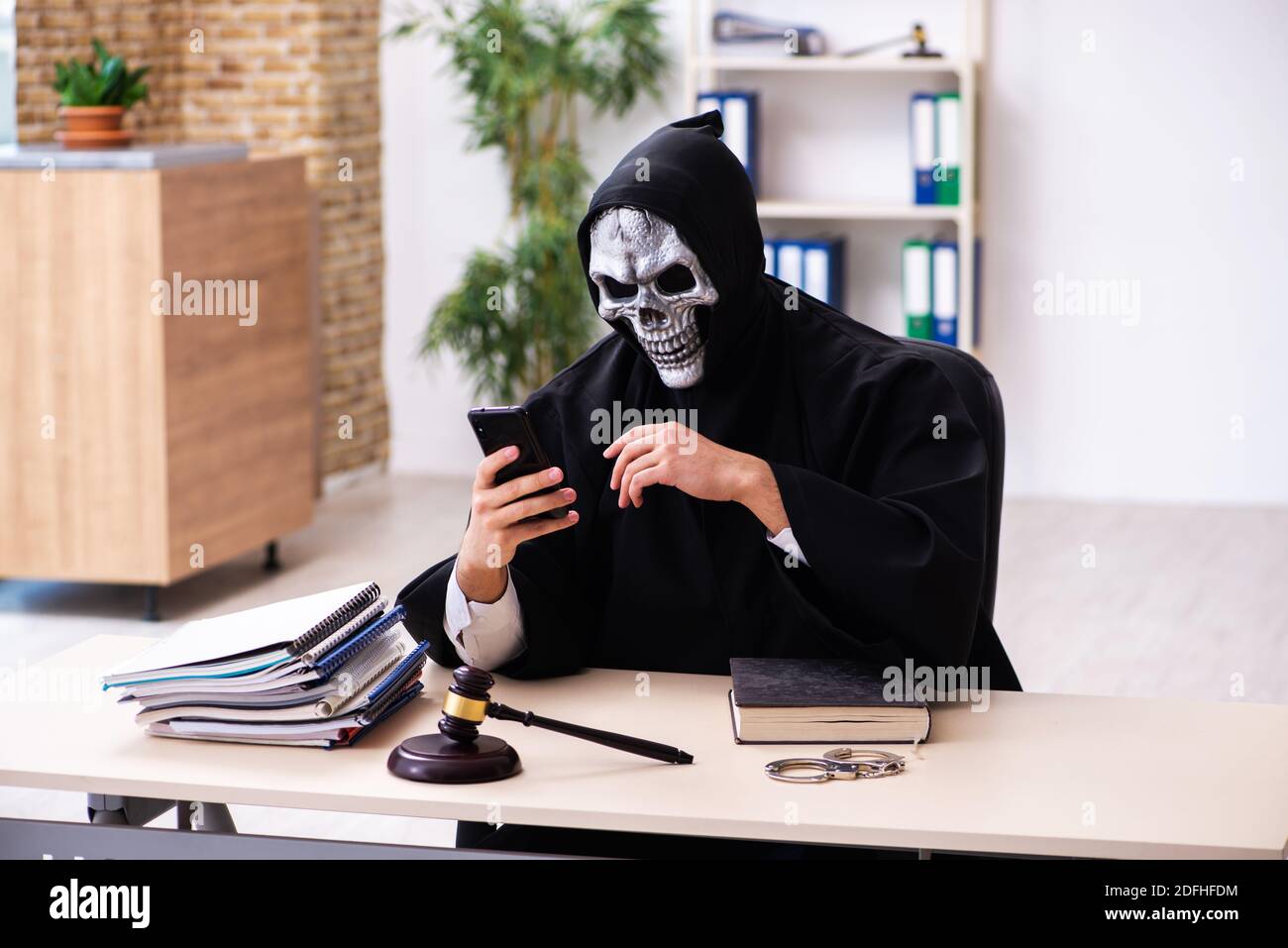 Devil judge working in the courthouse Stock Photo - Alamy