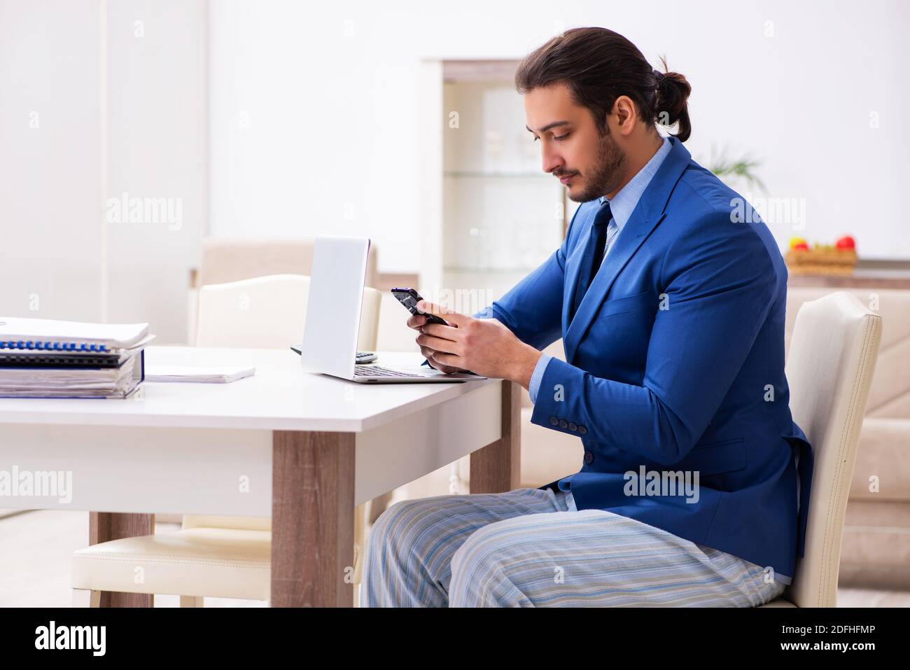 Young employee working from house in self-isolation concept Stock Photo ...