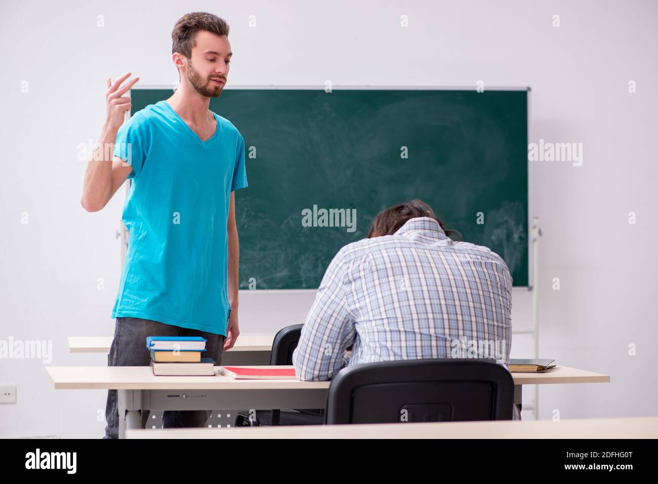 Male pupils in bullying concept in the classroom Stock Photo - Alamy