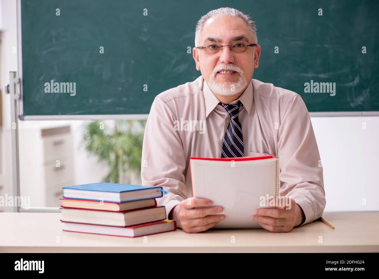 Old experienced teacher in the classroom Stock Photo - Alamy
