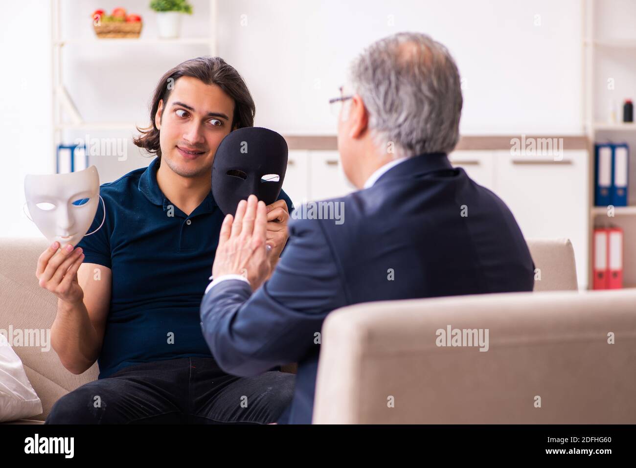 Man wearing masks during psychotherapy session Stock Photo - Alamy