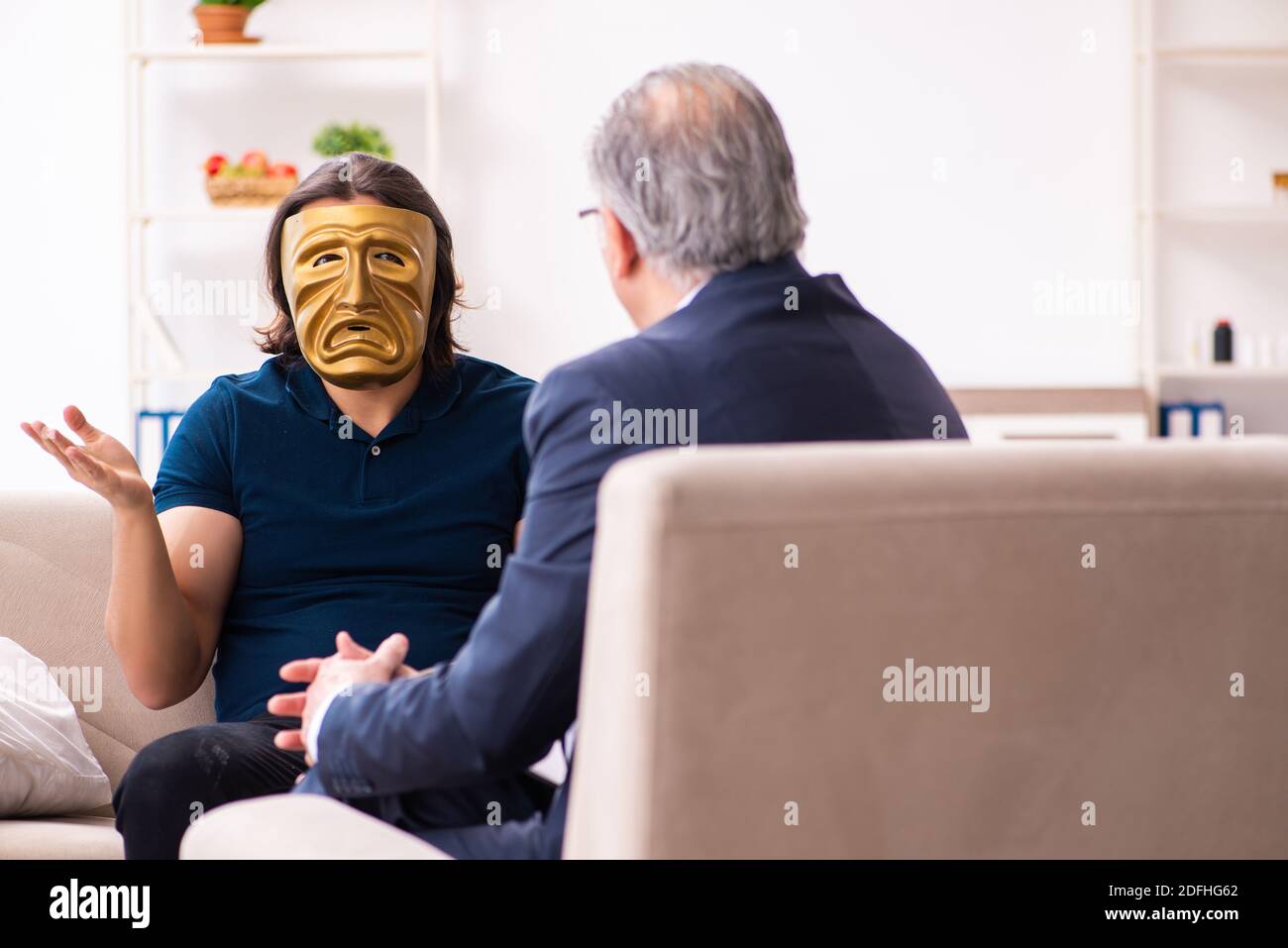 Man wearing masks during psychotherapy session Stock Photo - Alamy