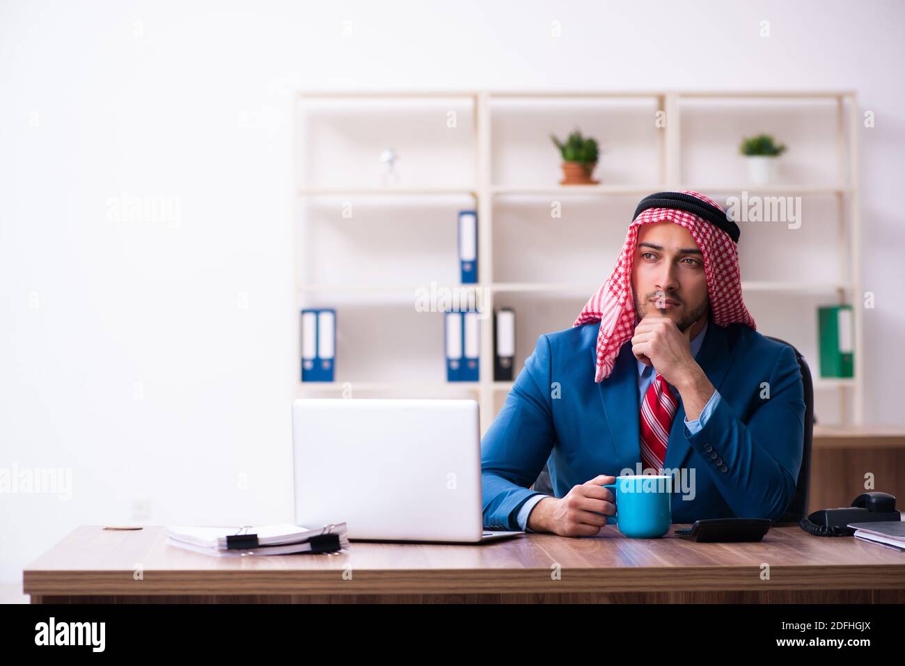 Young male arab employee working in the office Stock Photo - Alamy