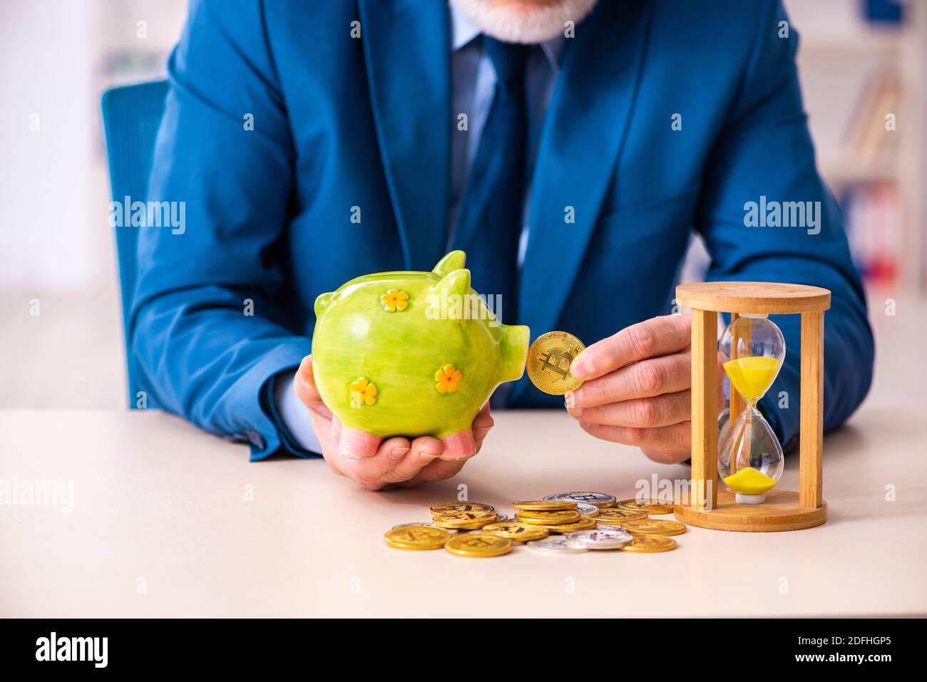 Old man earning money via internet in time management concept Stock ...