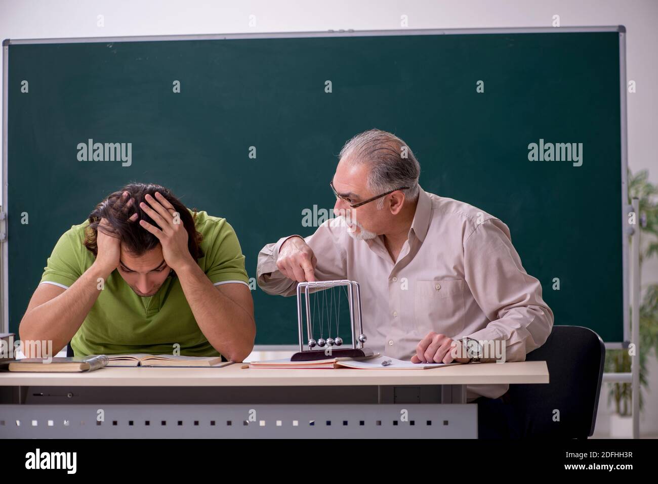 Old professor physicist and student in the classroom Stock Photo - Alamy