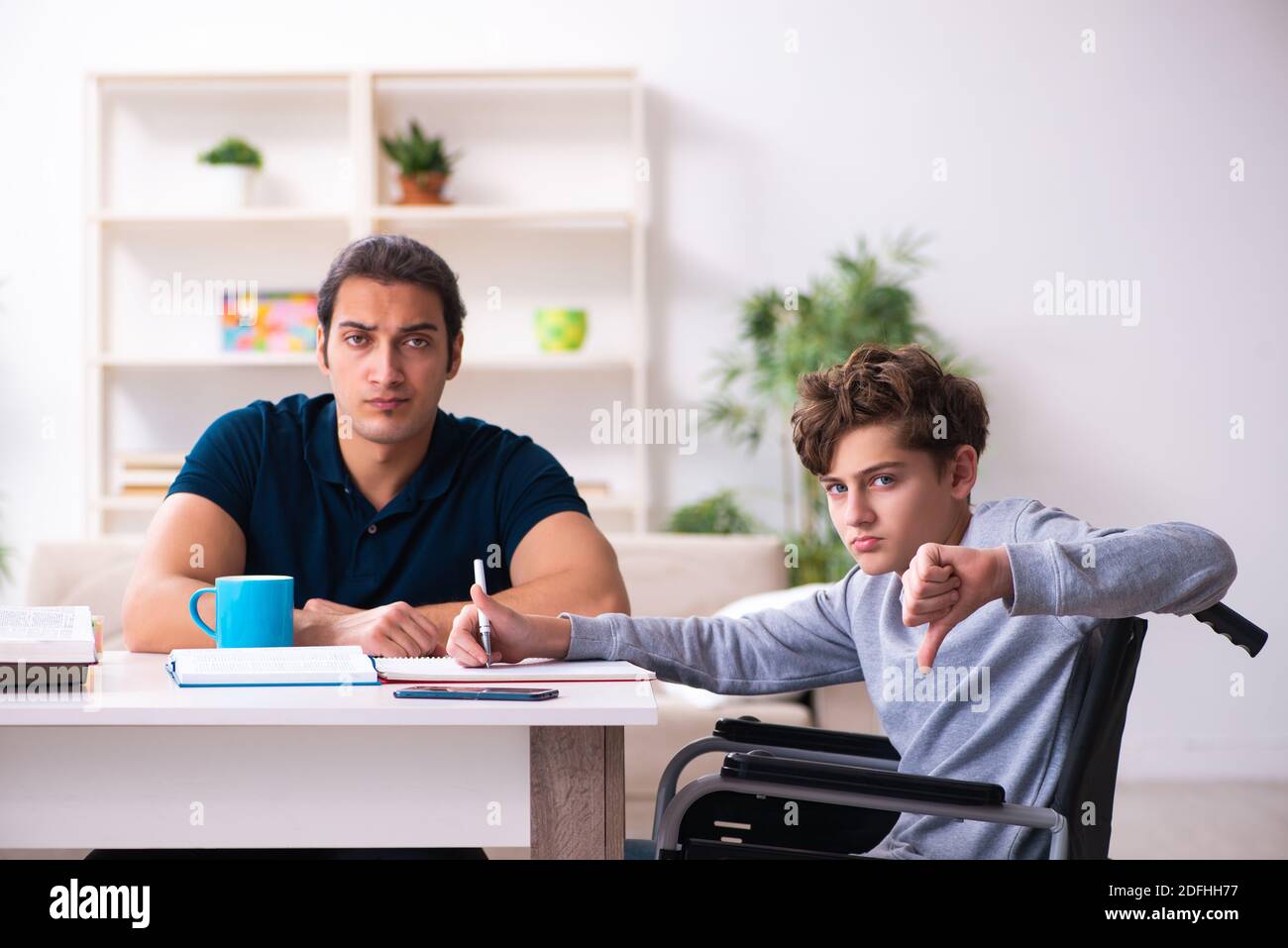Father and disabled son in the education concept Stock Photo - Alamy