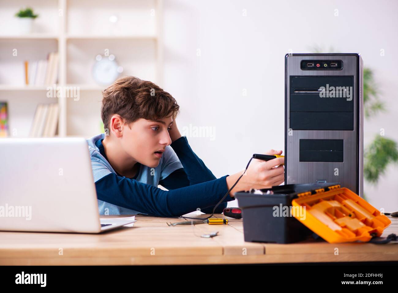 Teenager reparing computers at workshop Stock Photo - Alamy