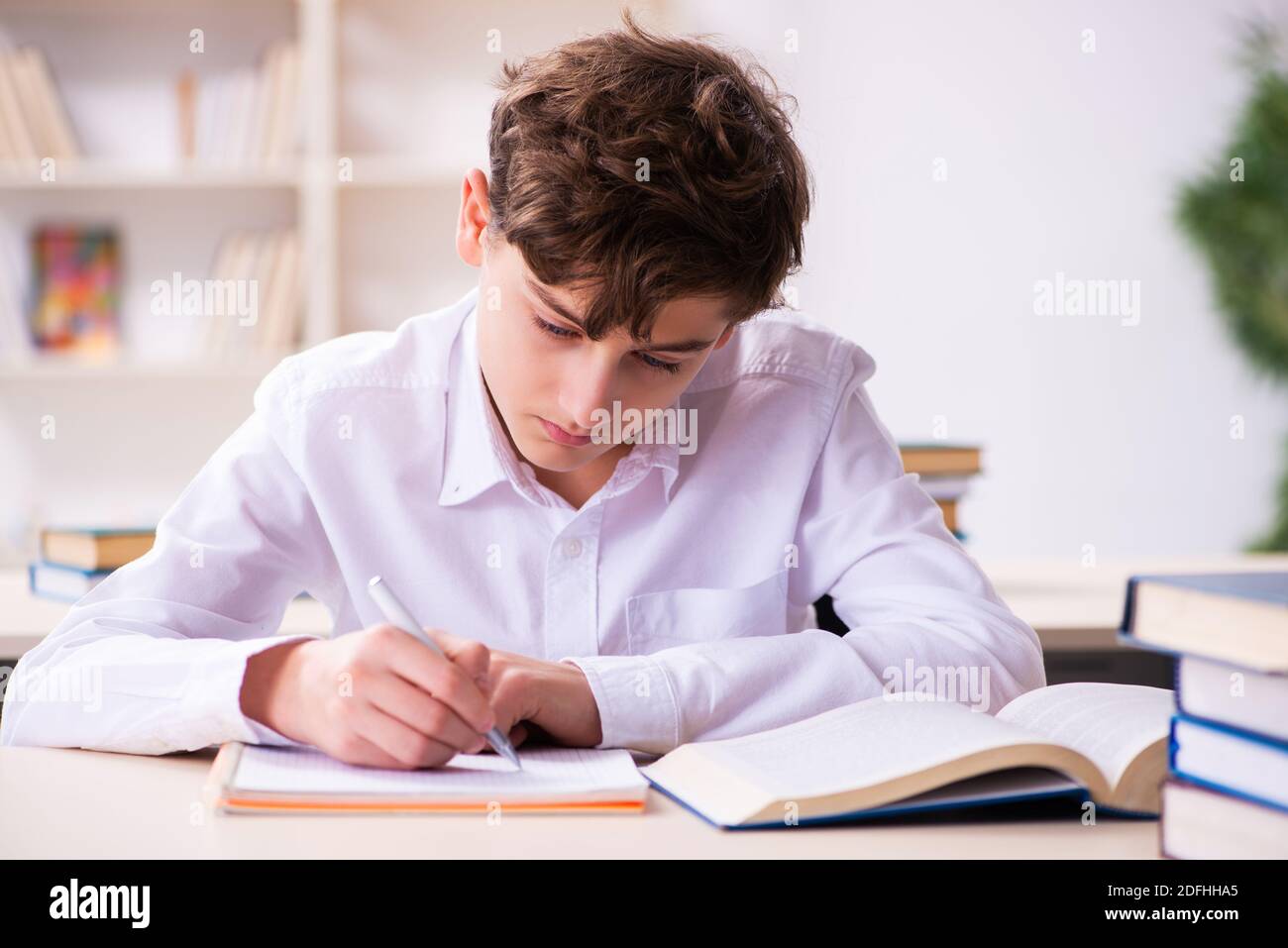 Schoolboy preparing for exam in the classroom Stock Photo - Alamy
