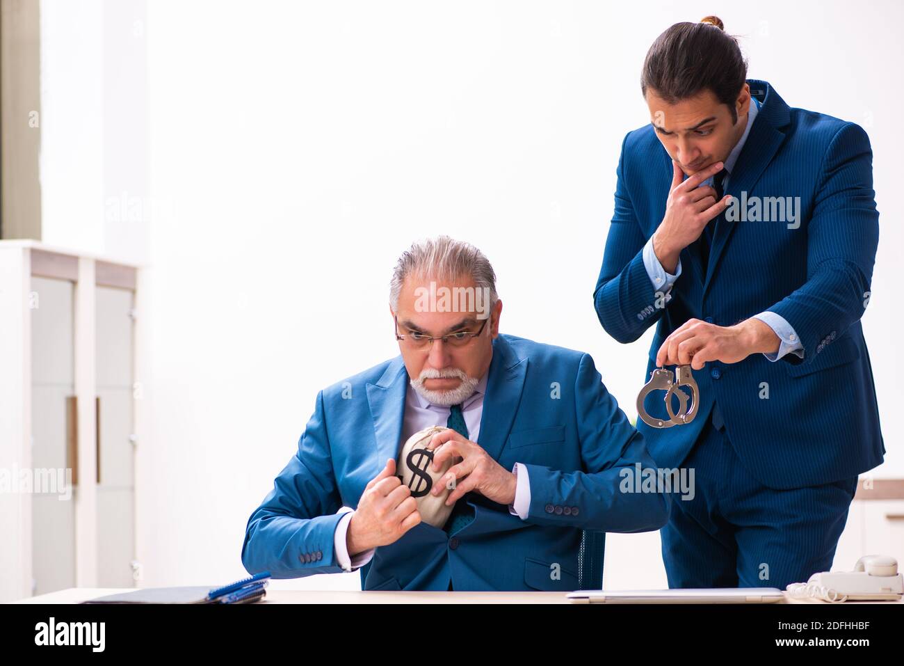 Male employee and cop in police investigation Stock Photo - Alamy
