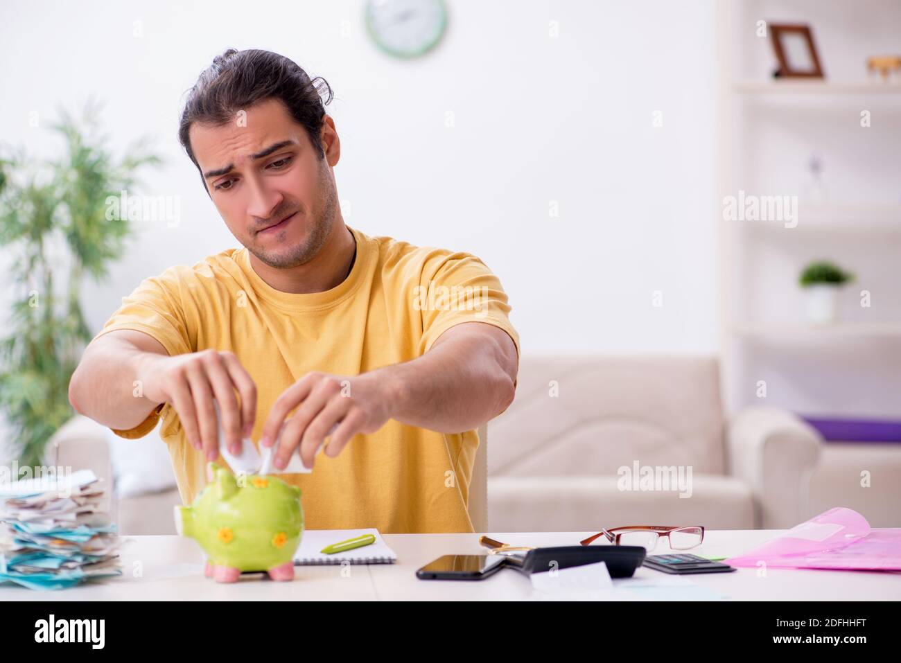 Young man in the budget planning concept Stock Photo - Alamy