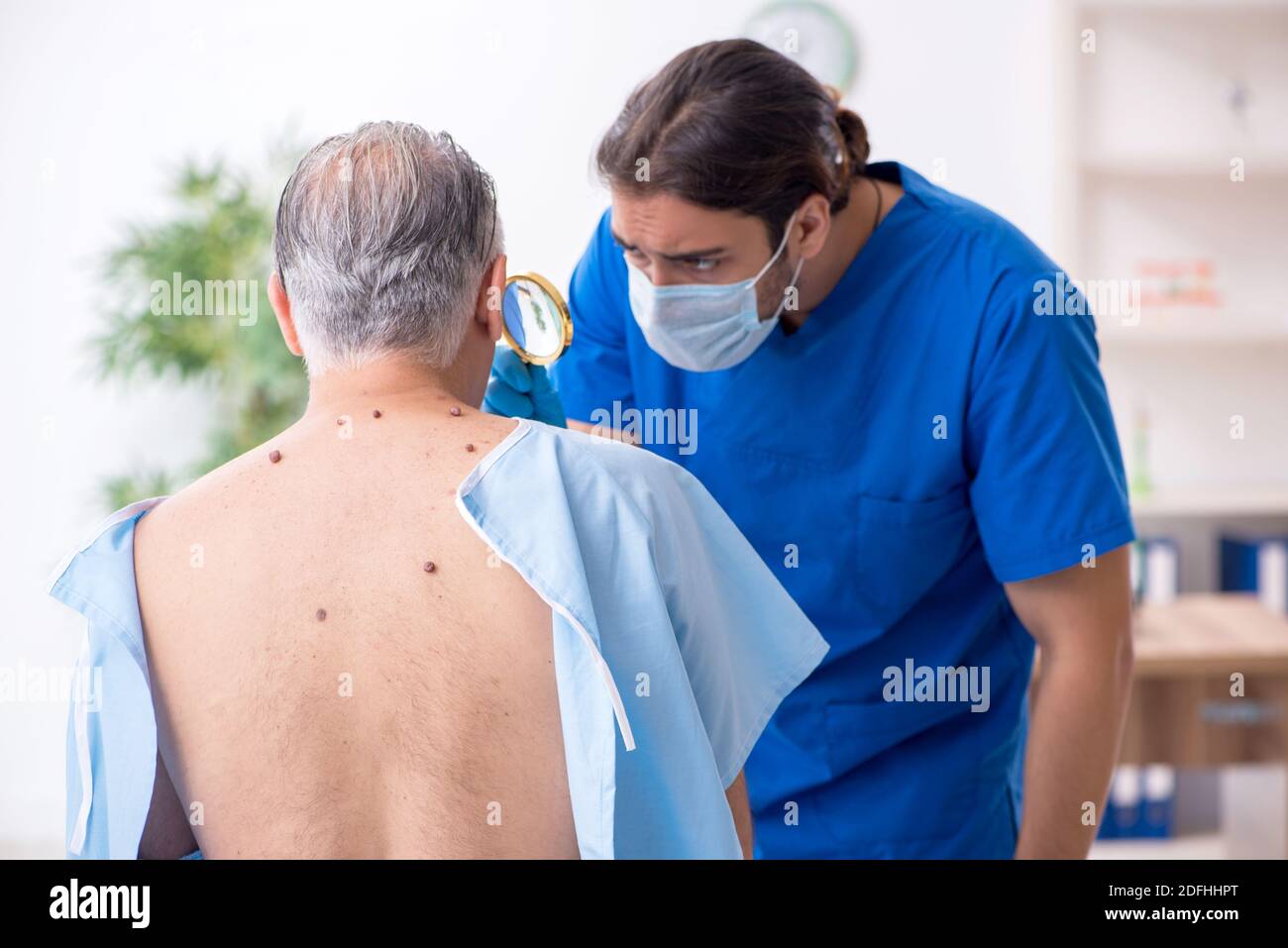Old man visiting male doctor dermatologist Stock Photo - Alamy