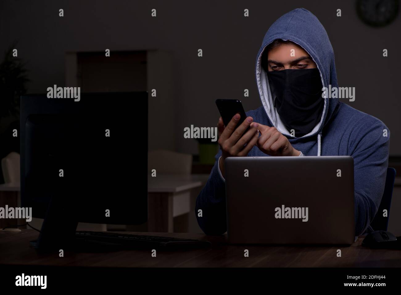 Male hacker hacking security firewall late in the office Stock Photo ...