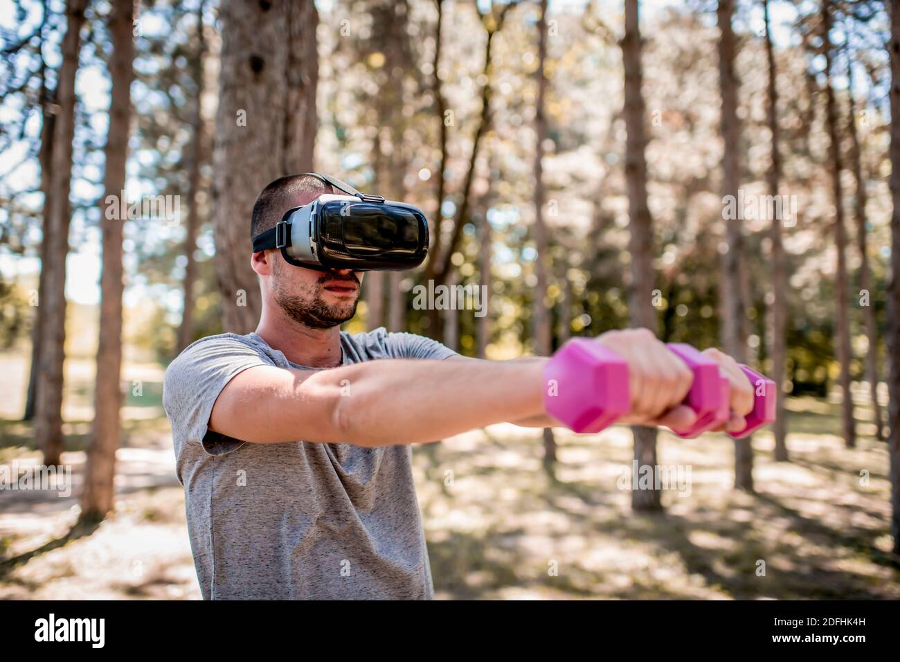 Young man doing workout with virtual reality heads Stock Photo - Alamy