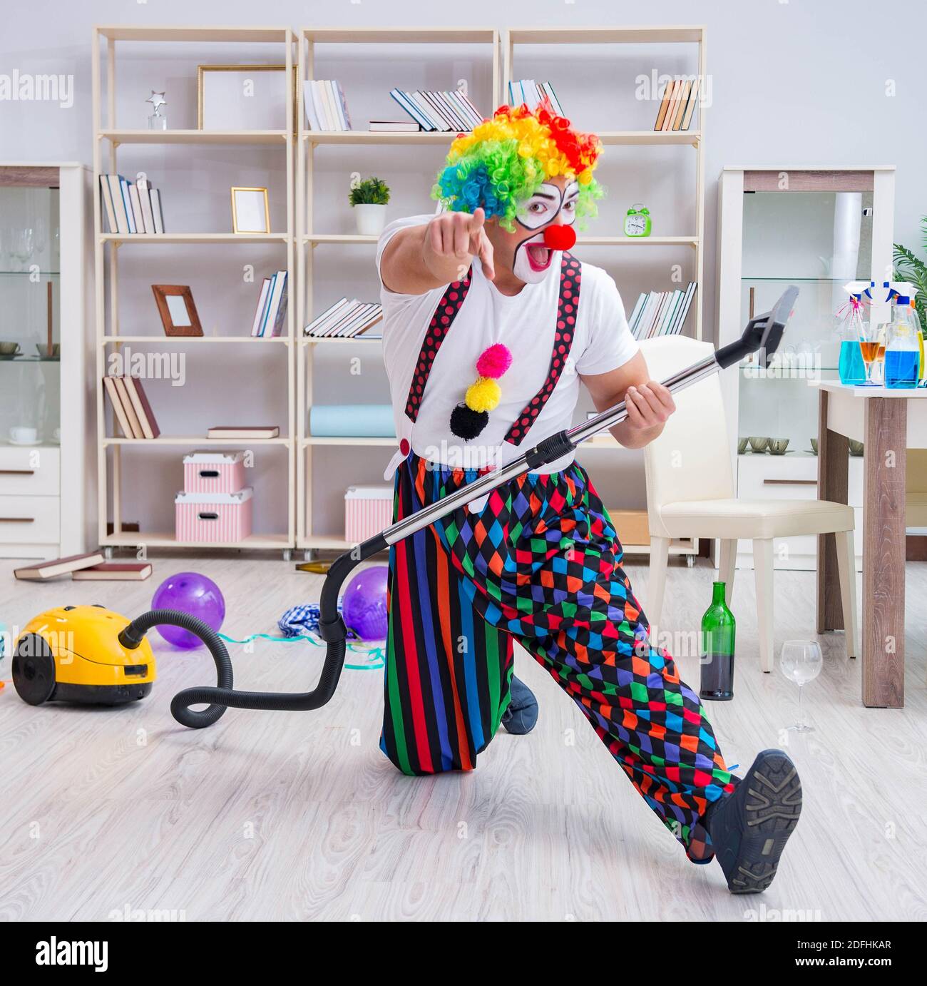 The funny clown doing cleaning at home Stock Photo - Alamy