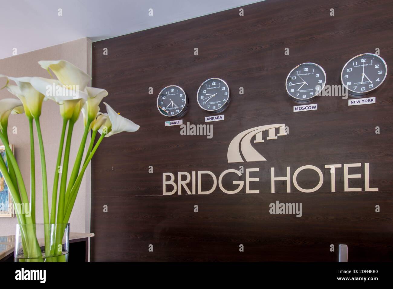 The hotel reception with desk and clocks Stock Photo - Alamy