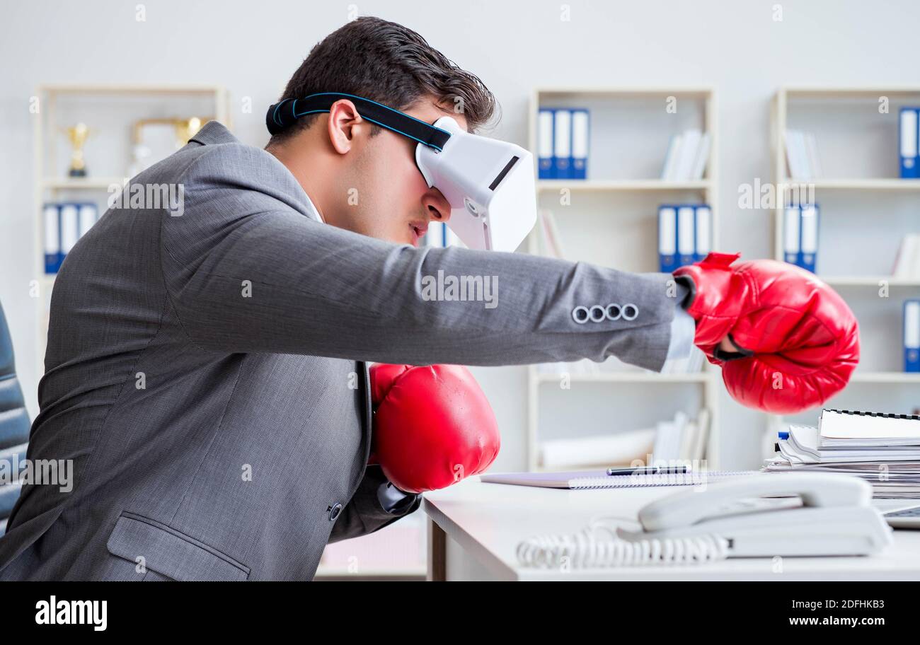 The man boxing in the office with virtual reality goggles Stock Photo ...