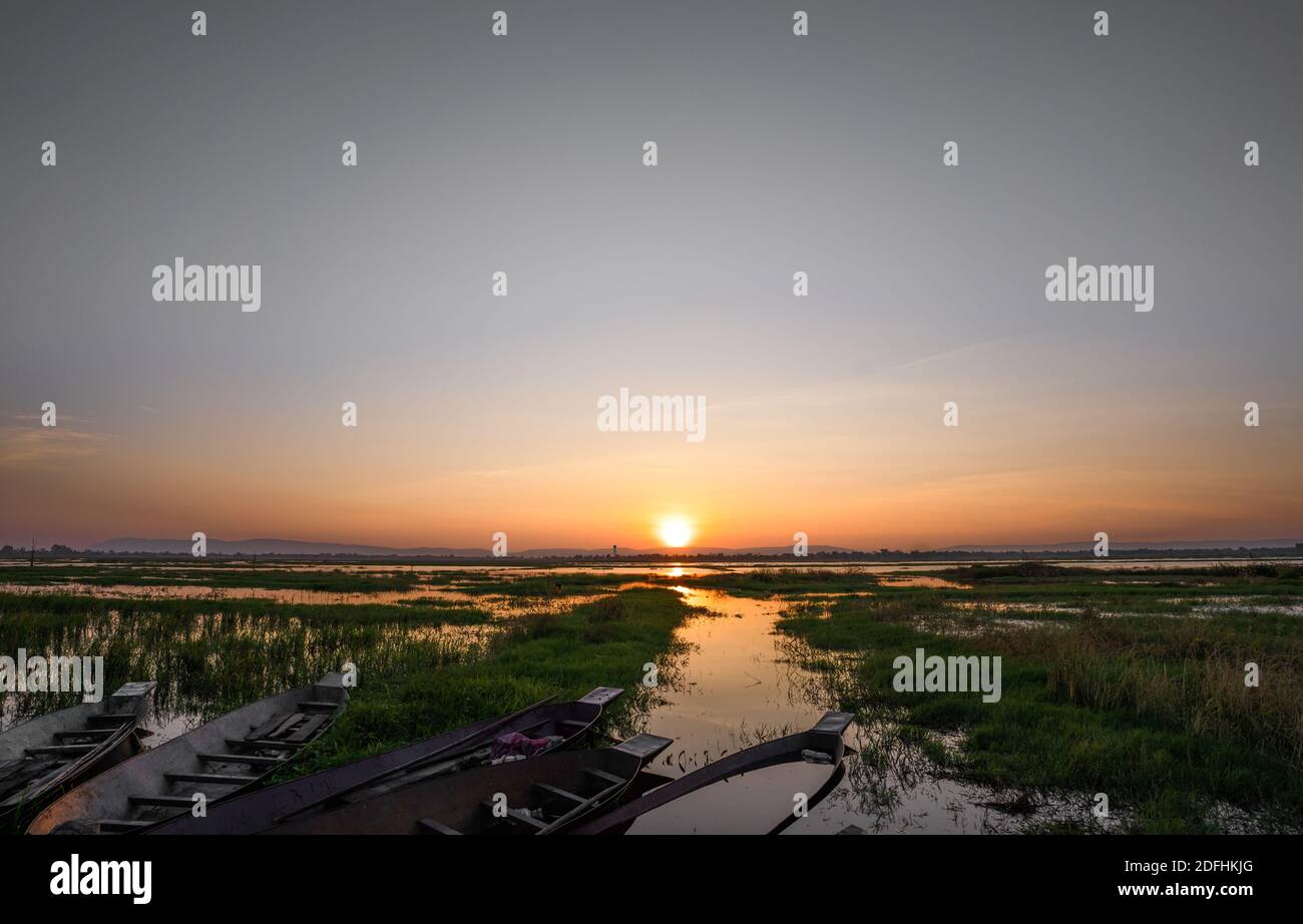 sunrise on small lek with fishing boat Stock Photo - Alamy